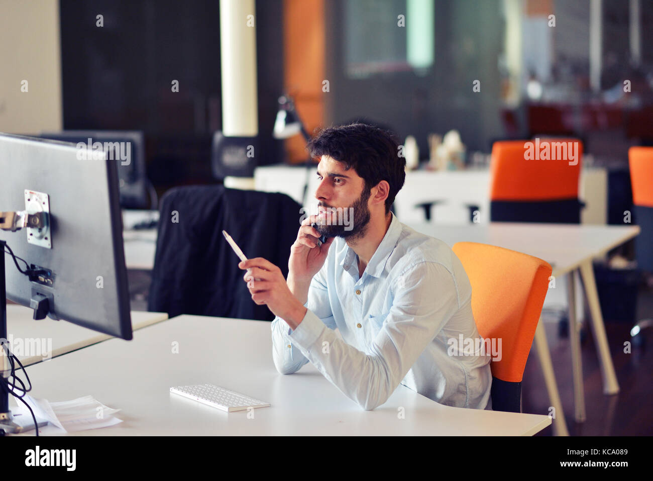 young business man working on desktop computer at his desk in modern ...