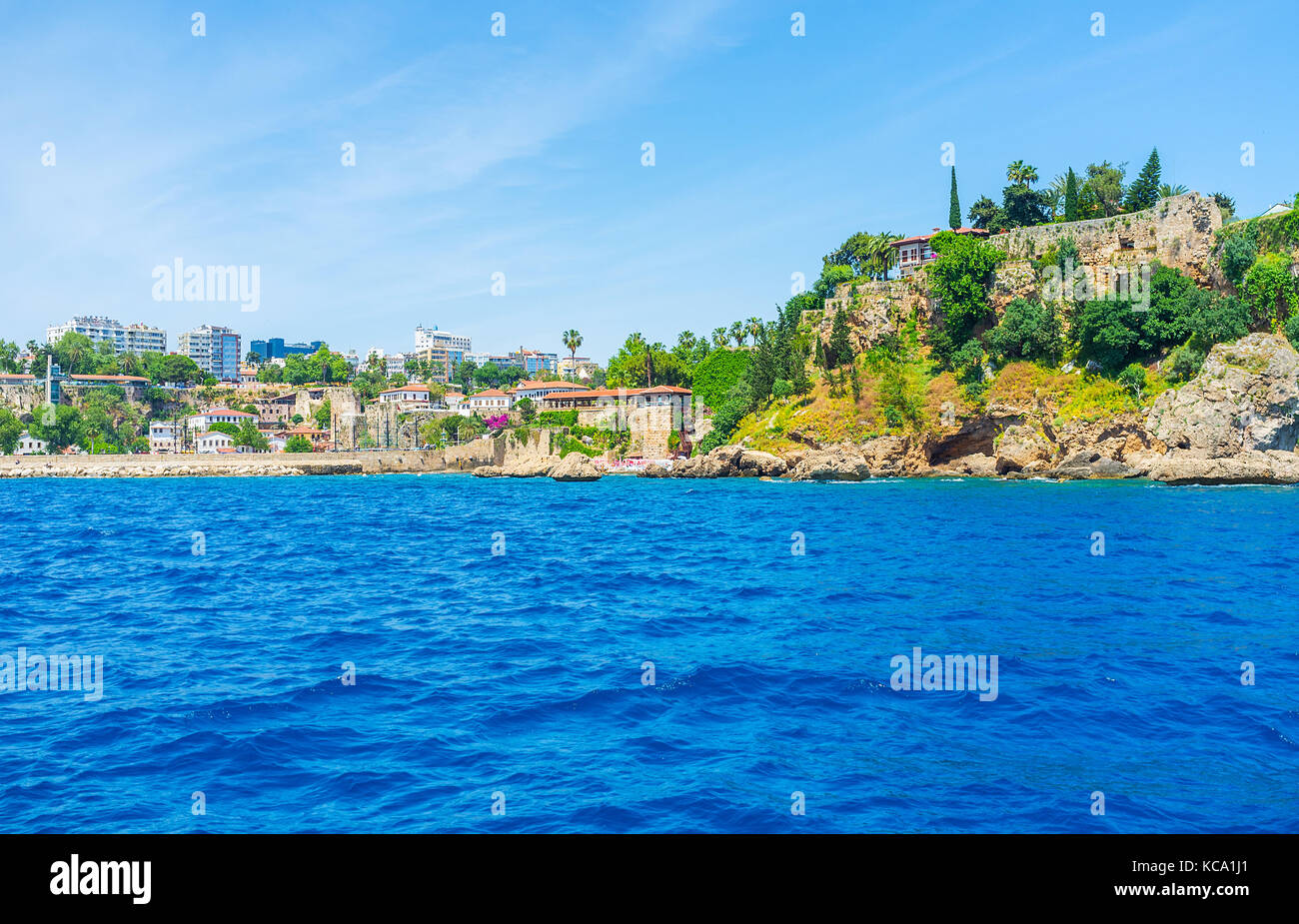 The rocky coast of Antalya, its scenic cliffs covered with lush ...