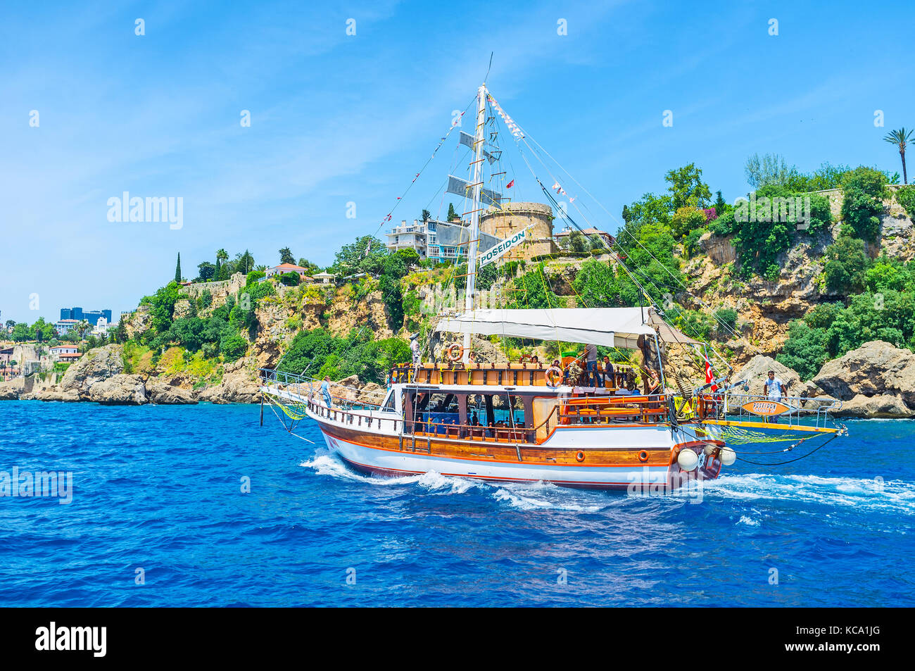 ANTALYA, TURKEY - MAY 12, 2017: The tourist yacht sails along the rocky ...