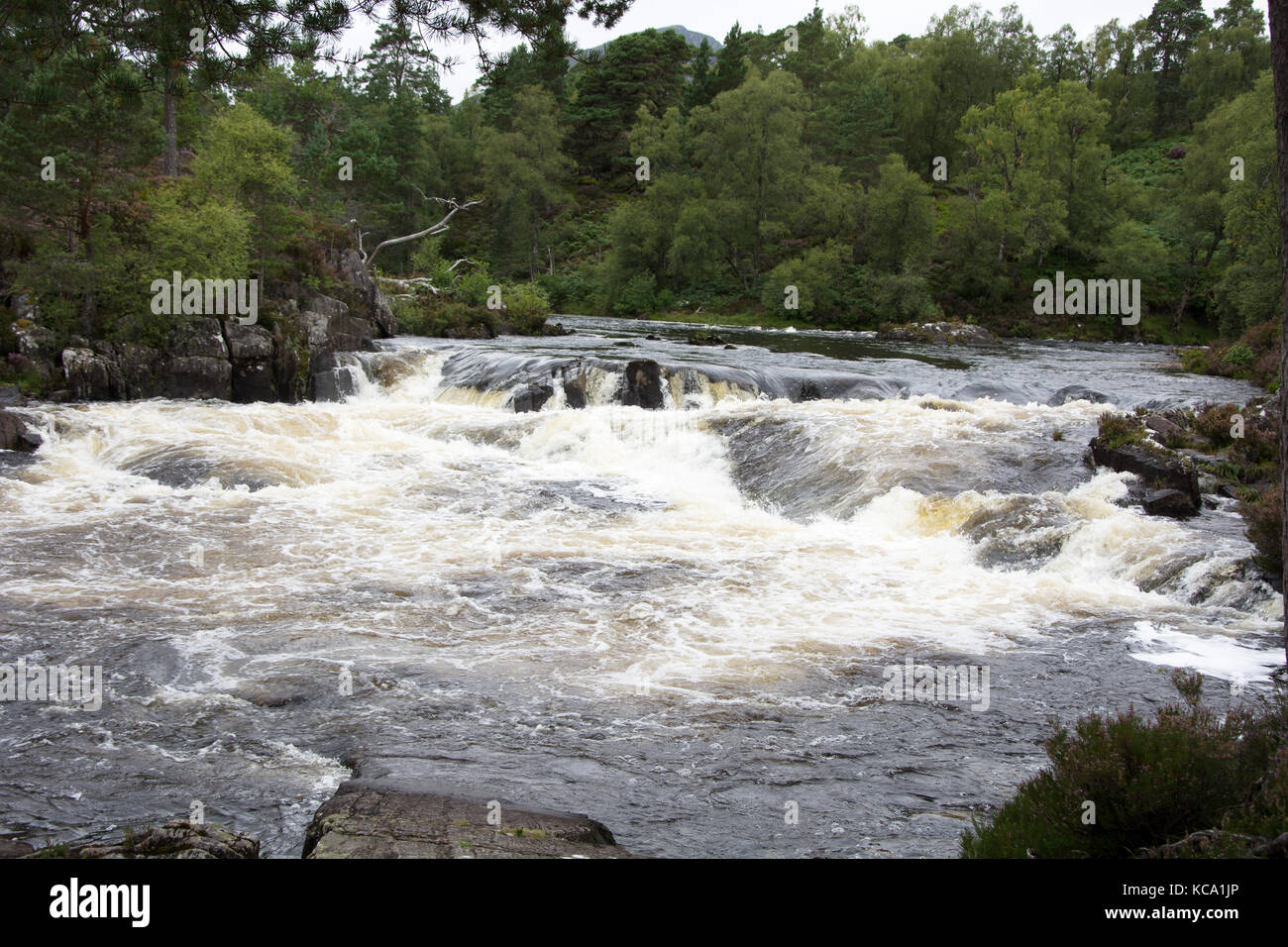Power of water tumbling over a small waterfall Stock Photo - Alamy