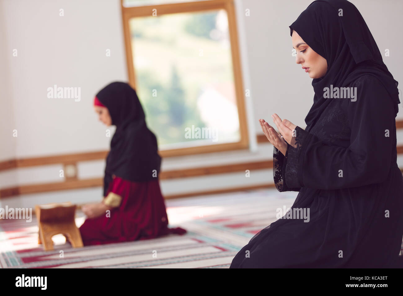Two Muslim women praying Stock Photo - Alamy