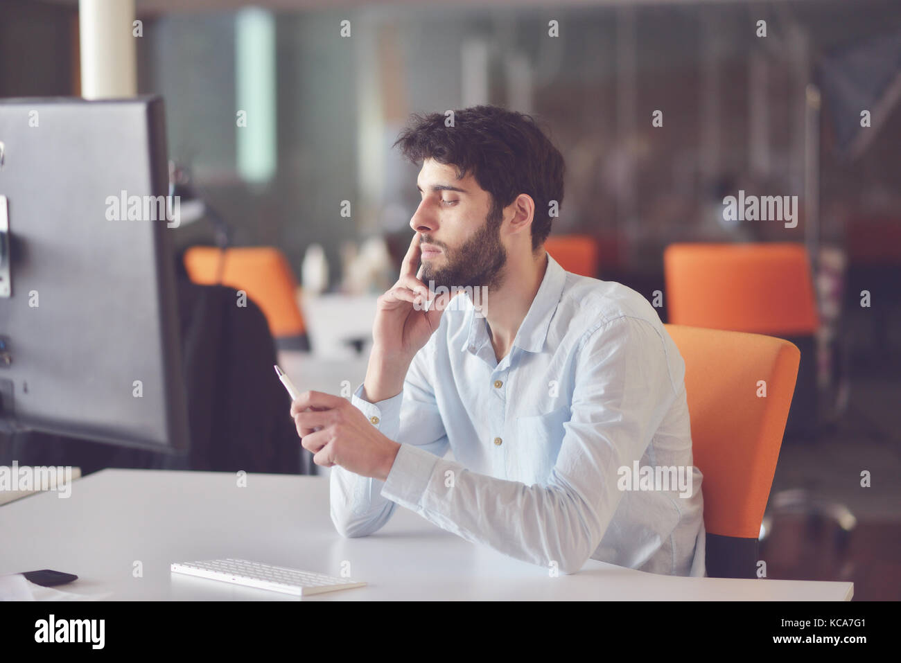 young business man working on desktop computer at his desk in modern ...