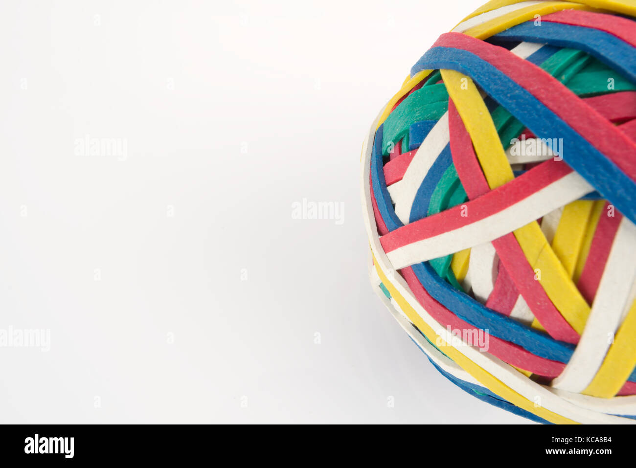 Rubber band ball made from many colourful elastic bands isolated on a ...