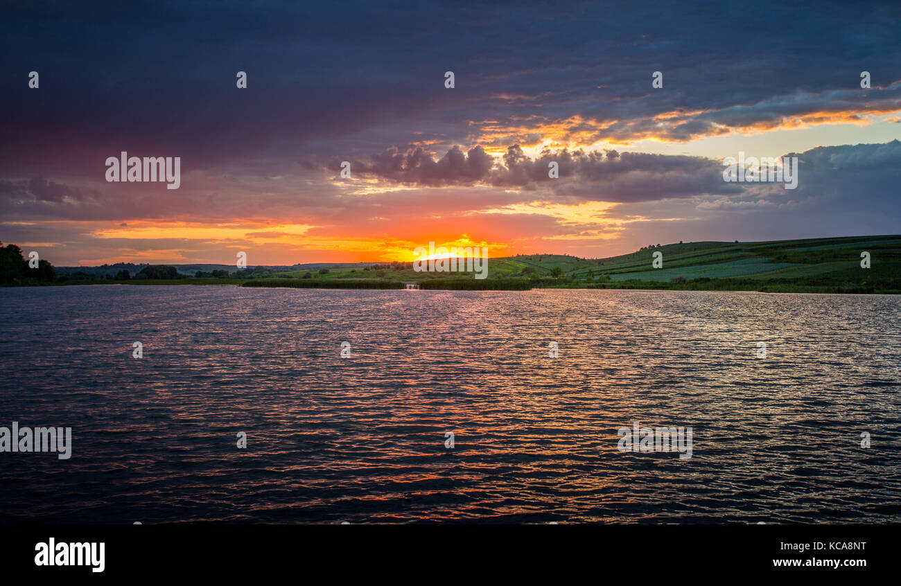Summer landscape. Sunset over water Stock Photo - Alamy