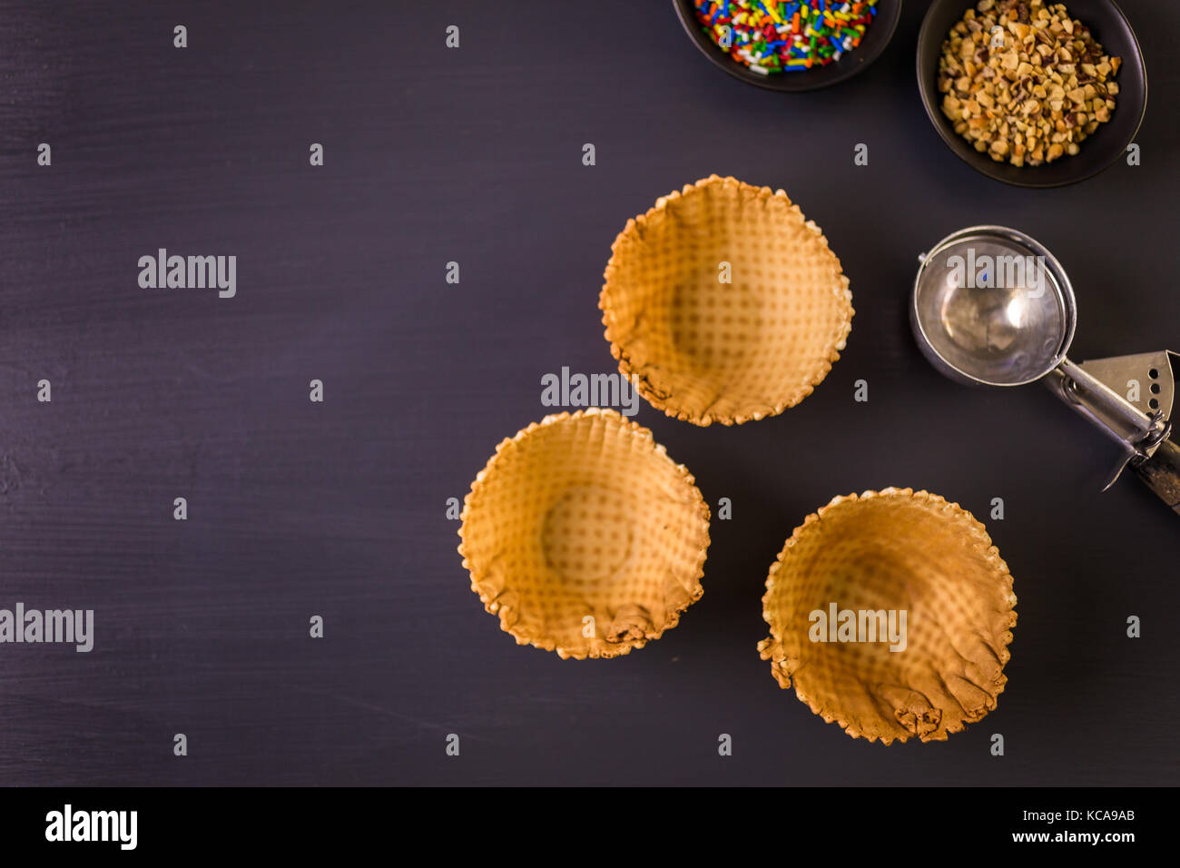 Empty waffle ice cream bowls on a black background Stock Photo - Alamy