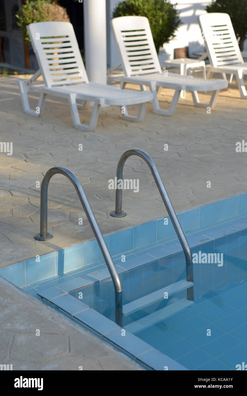 a metal ladder or set of steps going into a swimming pool from an ...