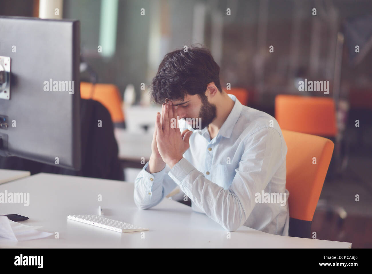 young business man working on desktop computer at his desk in modern ...