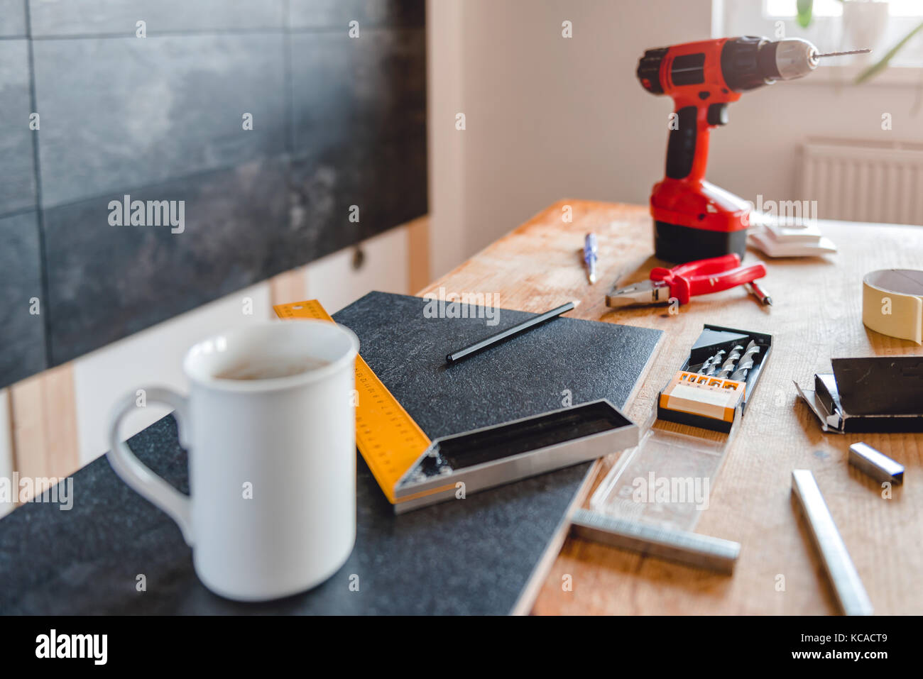 Tools on the table and white coffee mug Stock Photo - Alamy