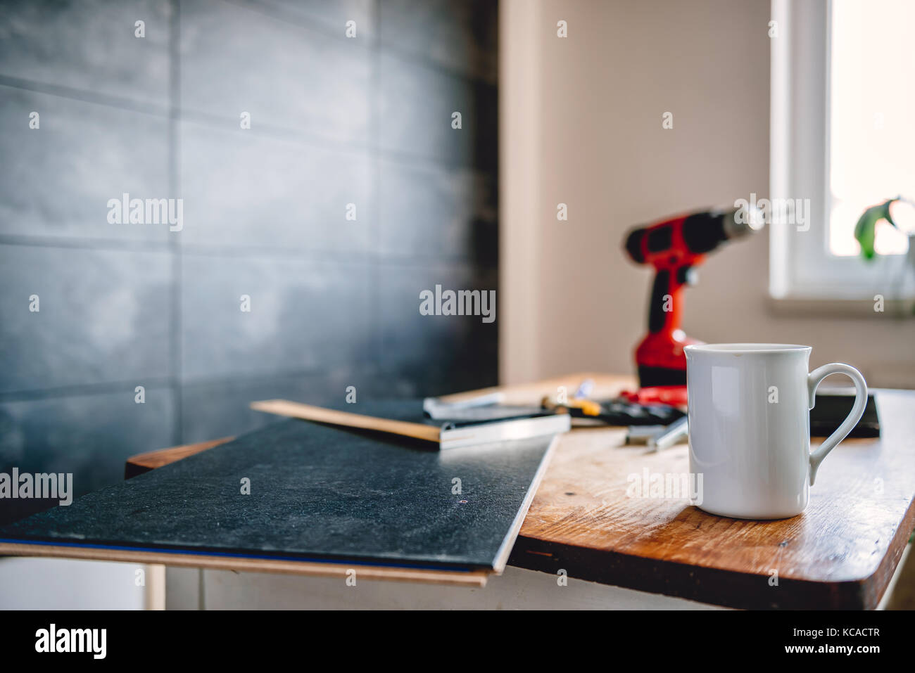White coffee mug on table with tools Stock Photo - Alamy