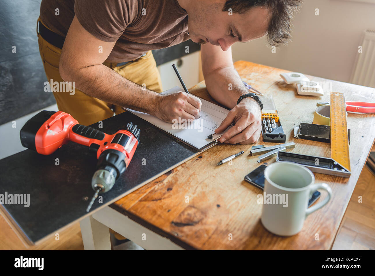 Man making draft plan using pencil on the table with tools Stock Photo ...