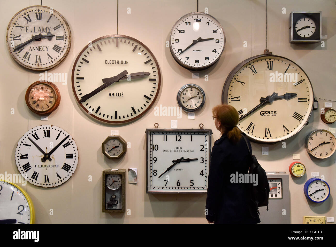 London, UK. 3rd Oct, 2017. A visitor views antique clocks on display by ...