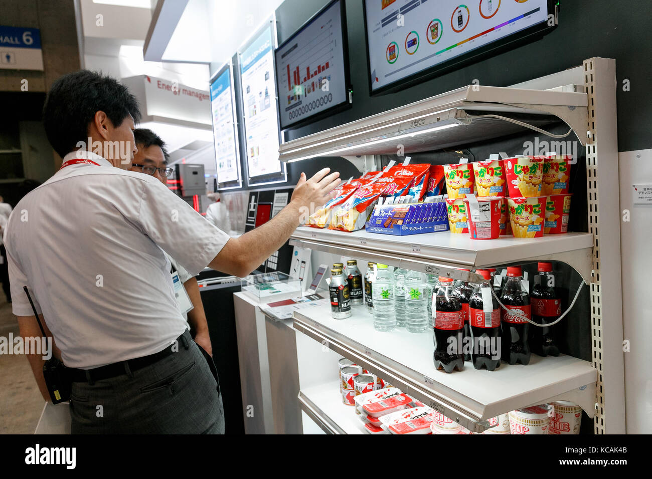 Visitors look at muRata's technology for smart convenience store at ...