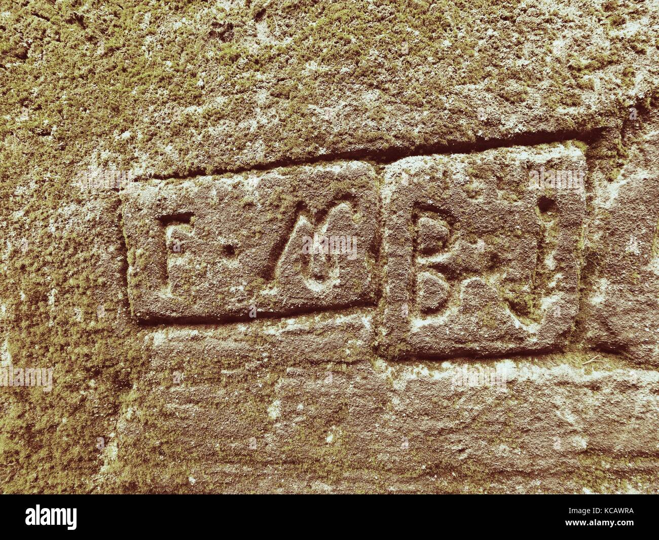 Ancient gray stone wall with carved inscriptions. Sandstone Wall with ...