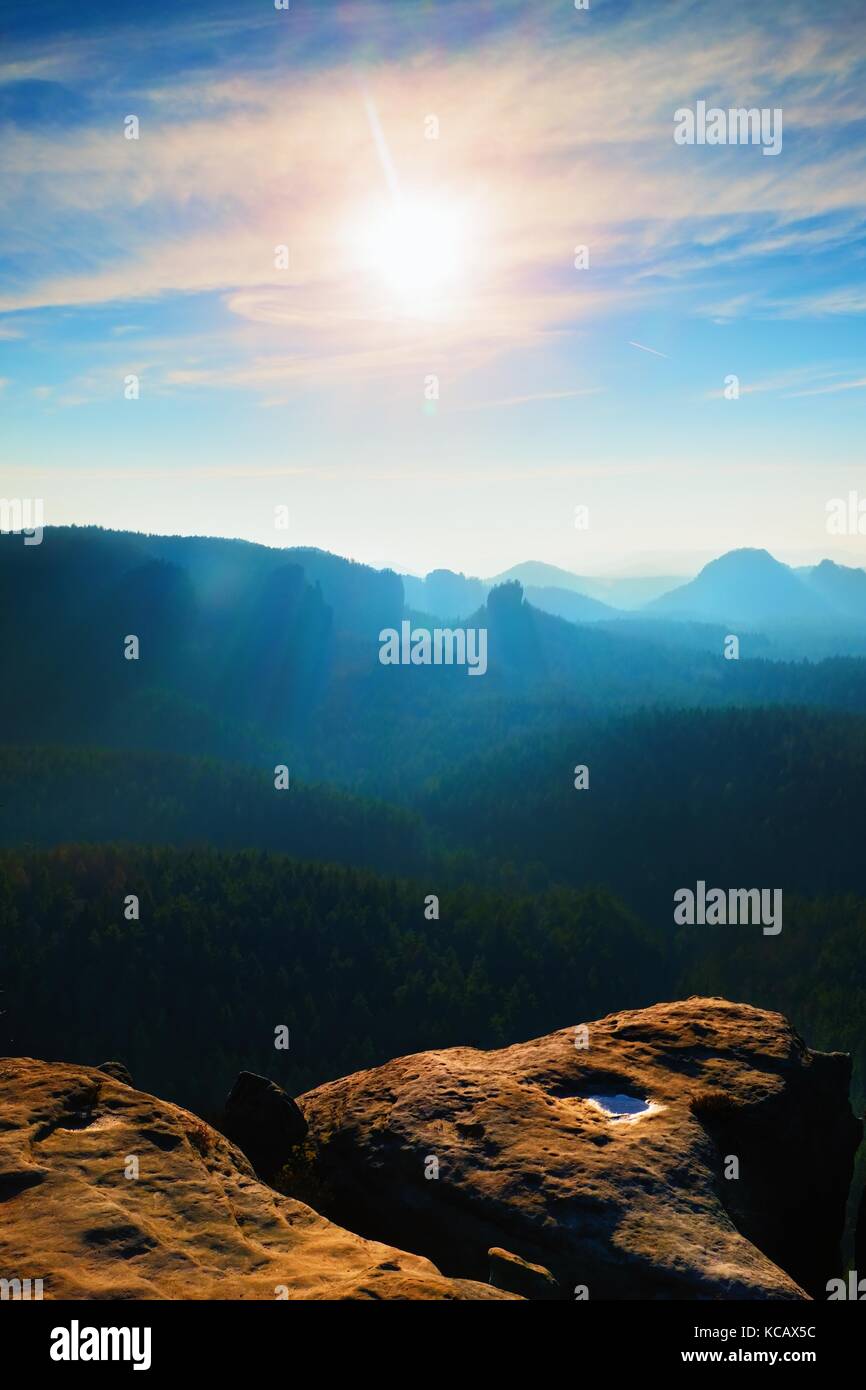 Spring misty morning in forest landscape. Majestic peaks cut lighting ...