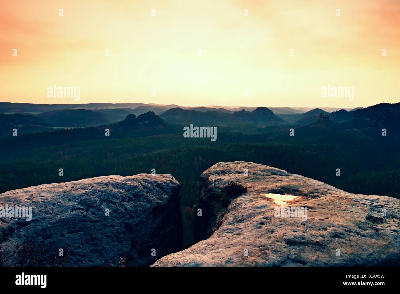 Morning view over sandstone cliff into forest valley, daybreak Sun at ...