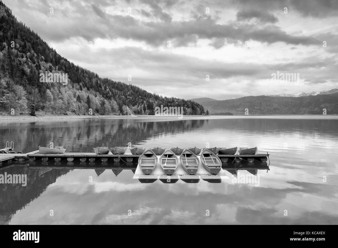 Blue Alps lake with Rental rowing boats in marina. Wharf for trip ships ...
