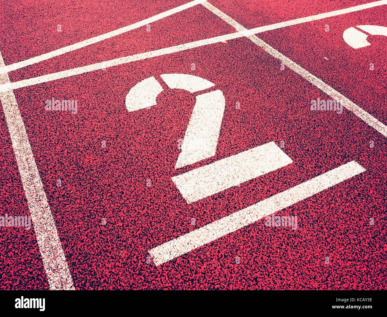 Number two. Big white track number on red rubber racetrack. Gentle ...
