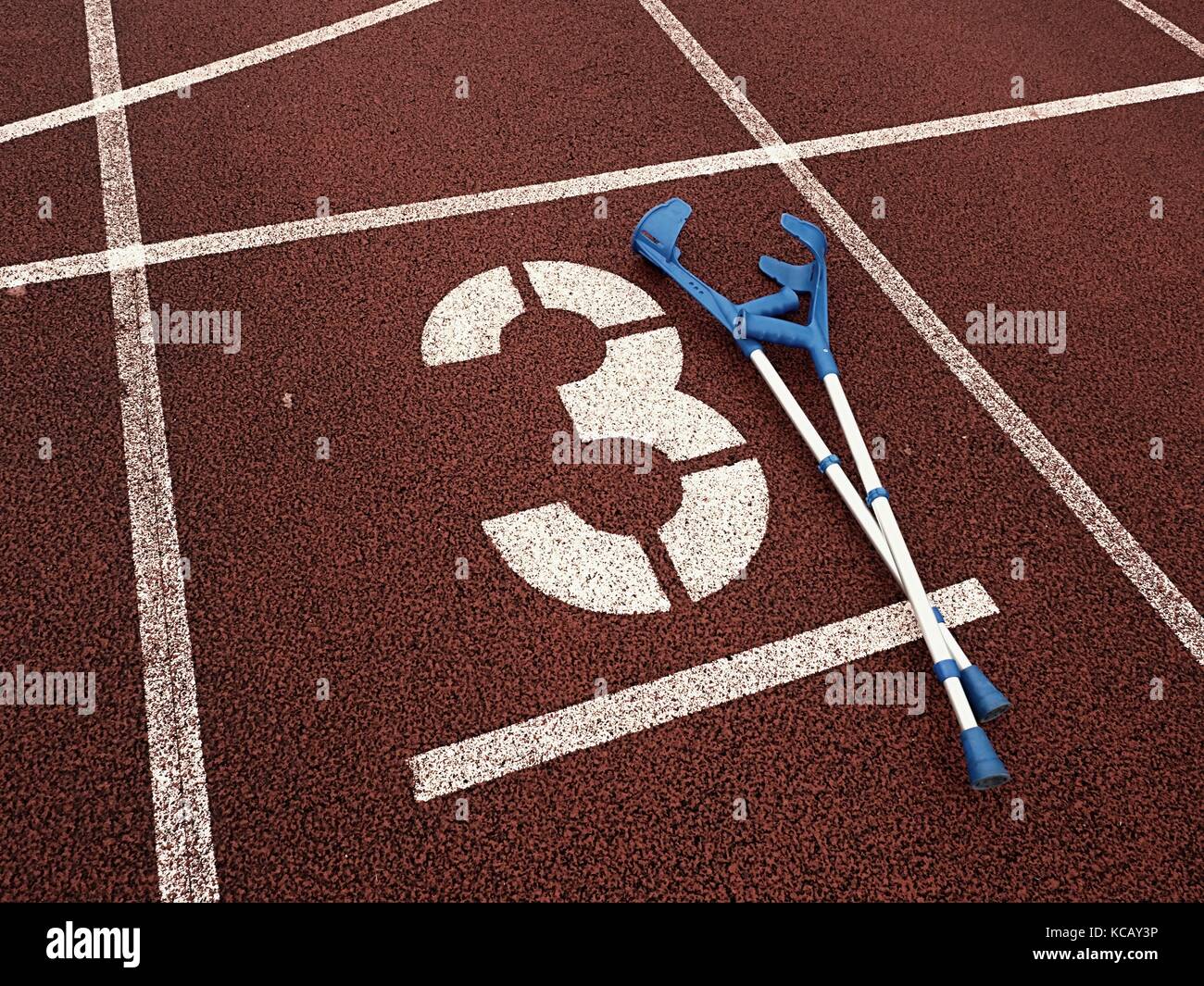 Medicine crutch for broken leg. Number three. Big white track number ...