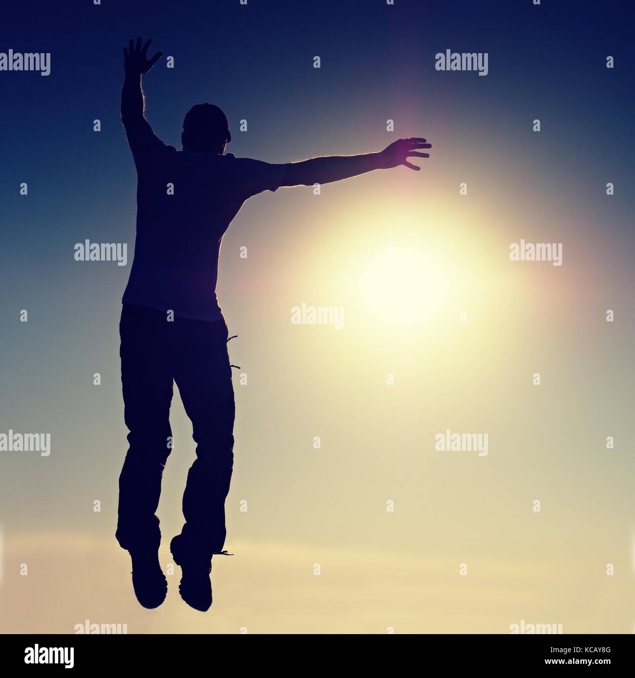 Man fly in air. Blue Toned effect. Man falling down with raised arms ...