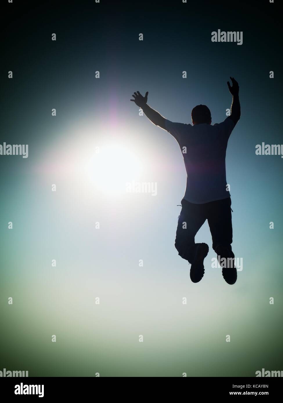 Man fly in air. Blue Toned effect. Man falling down with raised arms ...