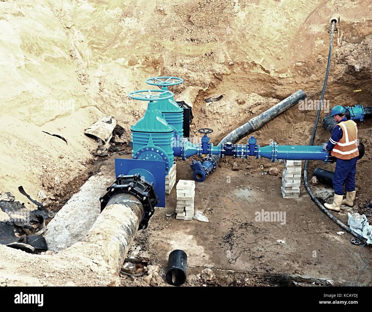Worker works underground for reconstrucion of drink water system ...