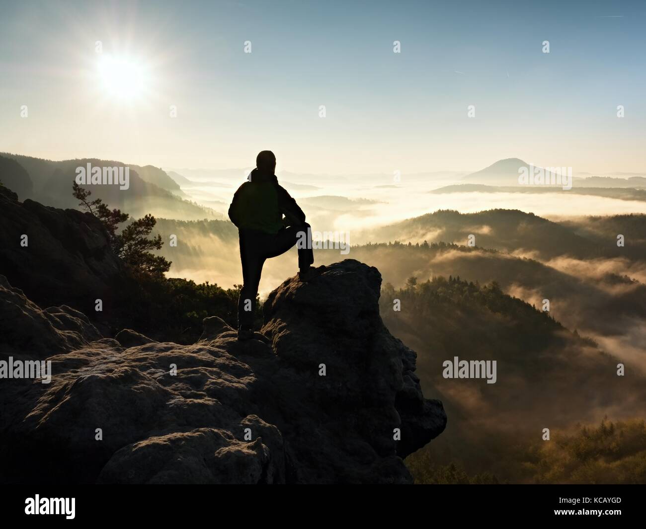 Man silhouette stay on sharp rock peak. Satisfy hiker enjoy view. Tall ...
