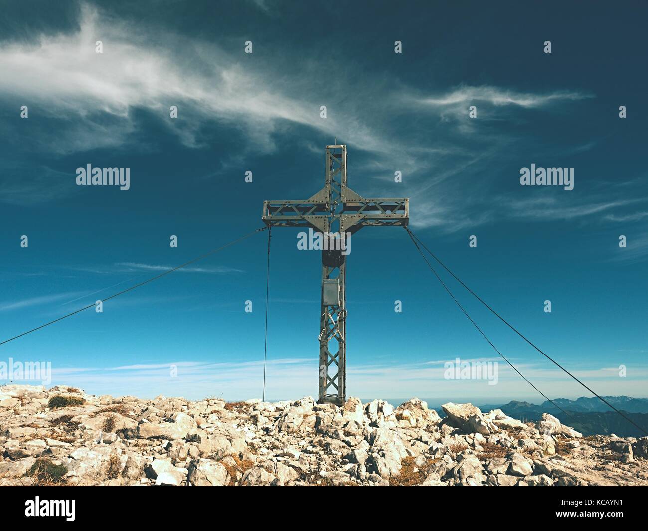 Praying summit cross on high rocky mountain. Steel artistic crucifix on ...