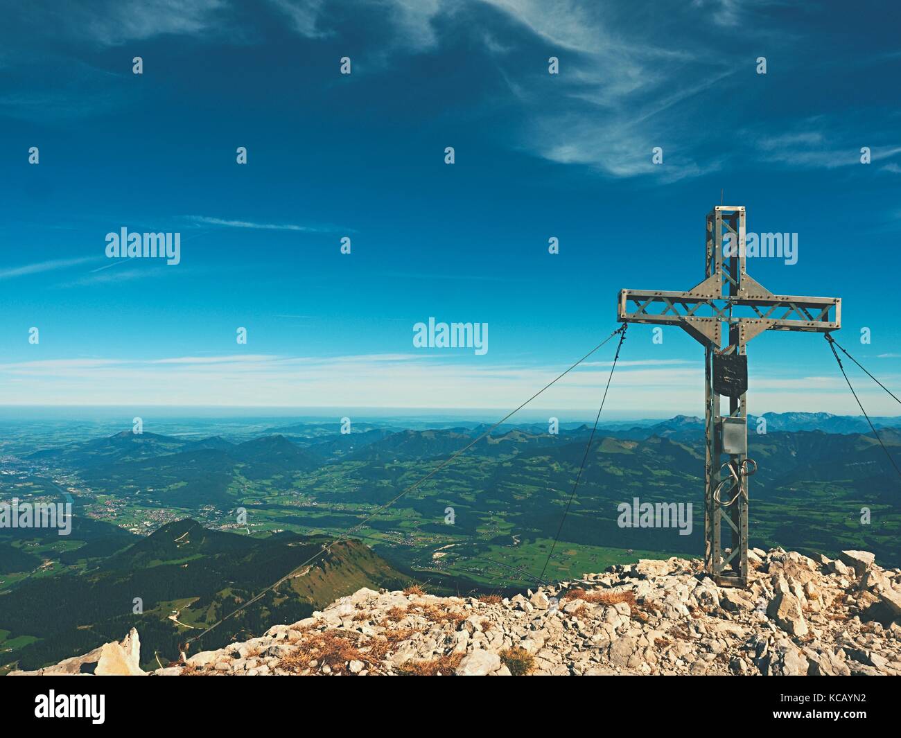 Praying summit cross on high rocky mountain. Steel artistic crucifix on ...