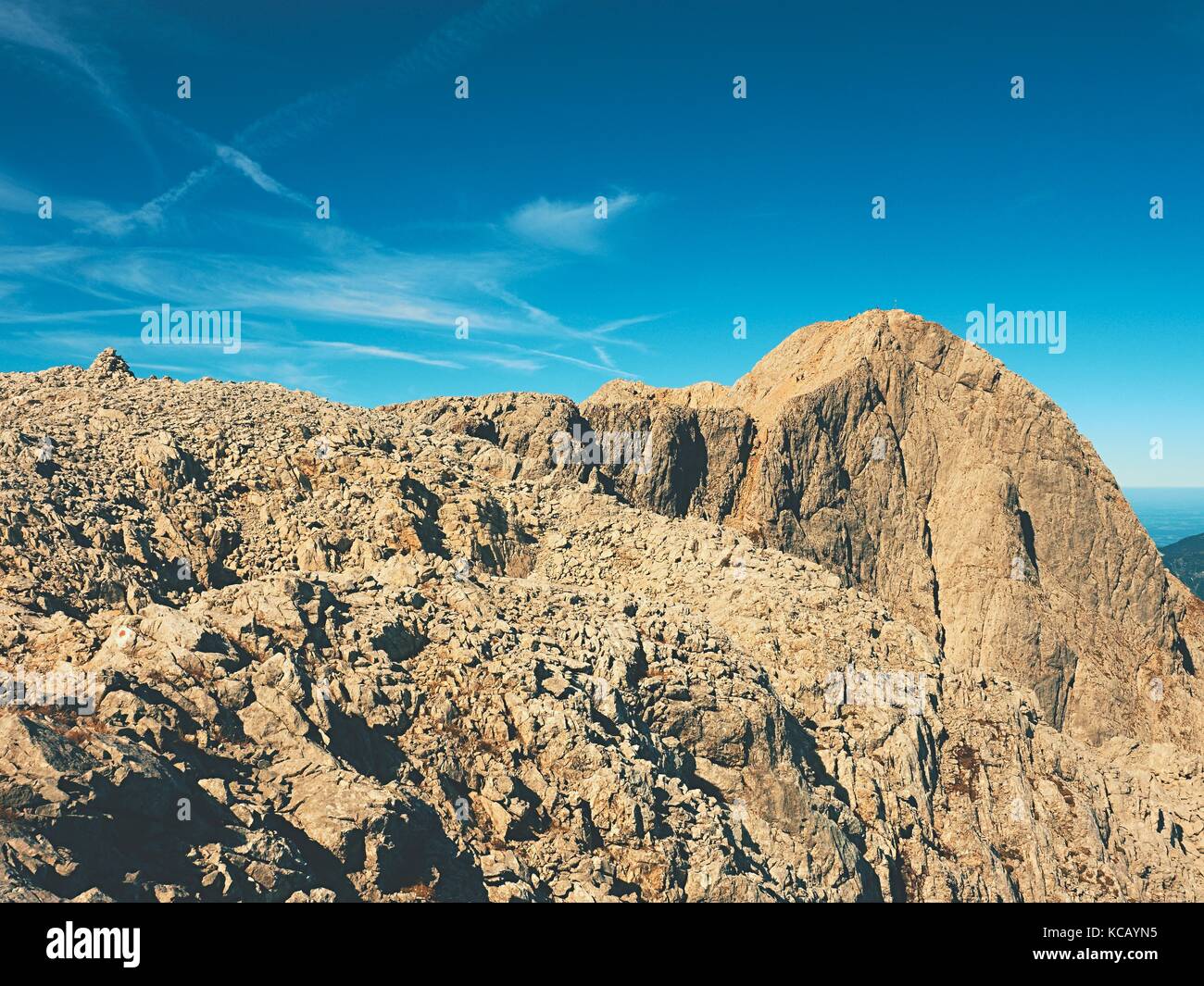 Lens flare light, strong effect. Morning sun between sharp rocks ...