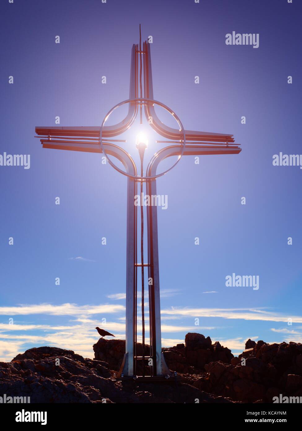 Praying summit cross on high rocky mountain. Steel artistic crucifix on ...