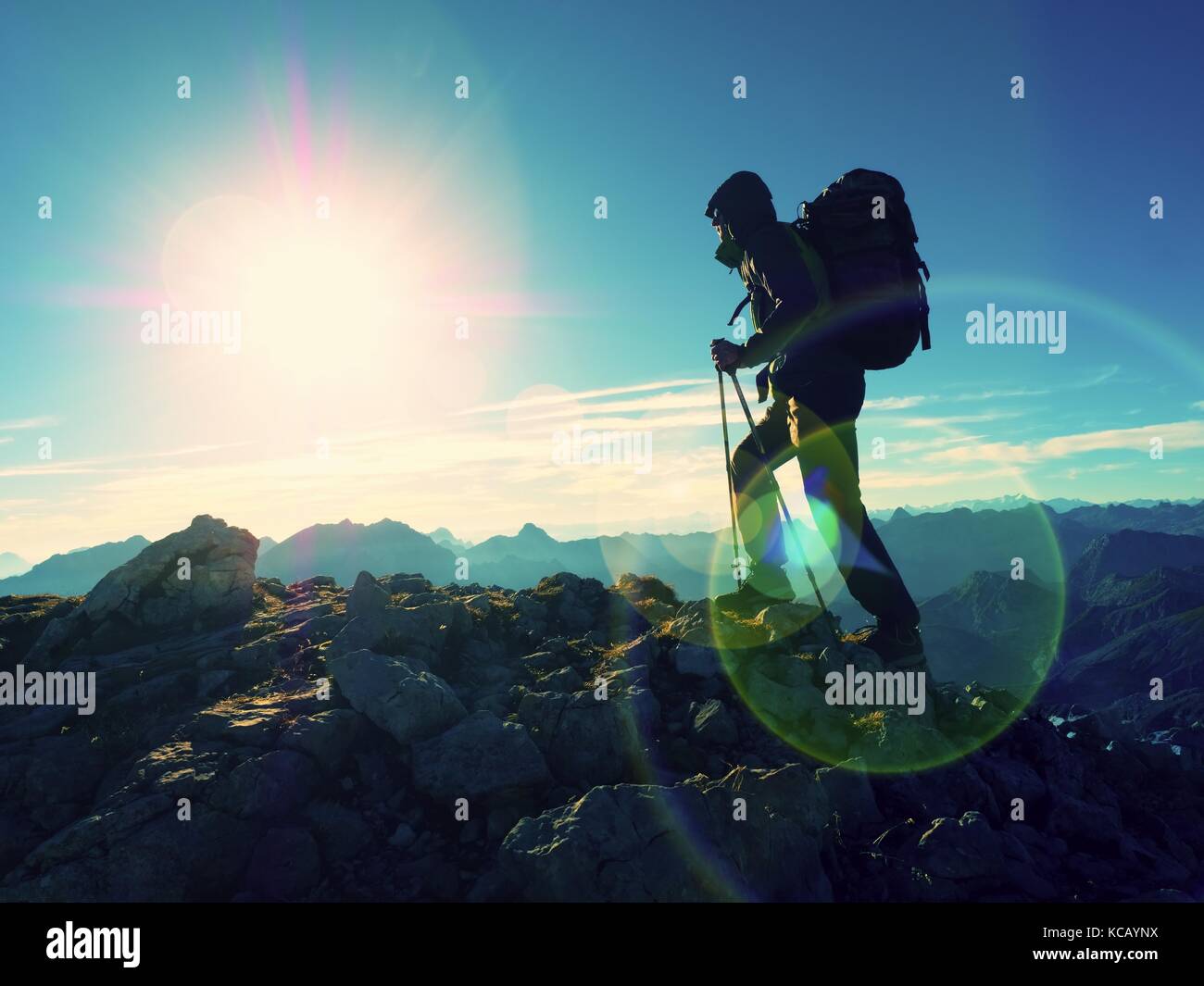 Lens flare light, strong defect. Tourist guide on trekking path with ...