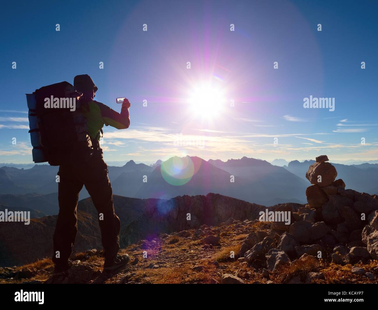 Lens flare light, strong defect. Hiker takes selfie photo. Man with big ...