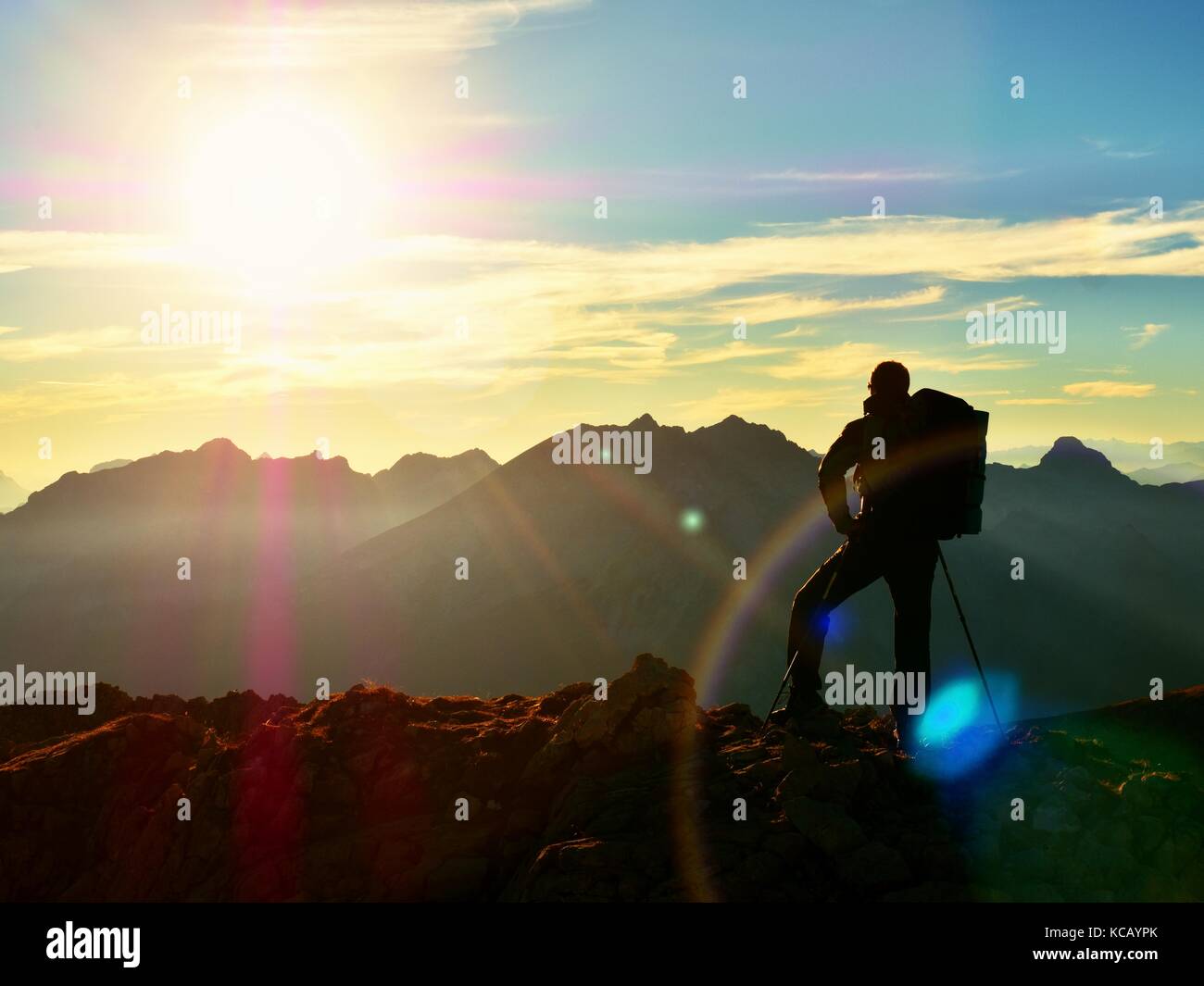 Lens flare light, strong effect. Bow light circles. Hiker takes selfie ...