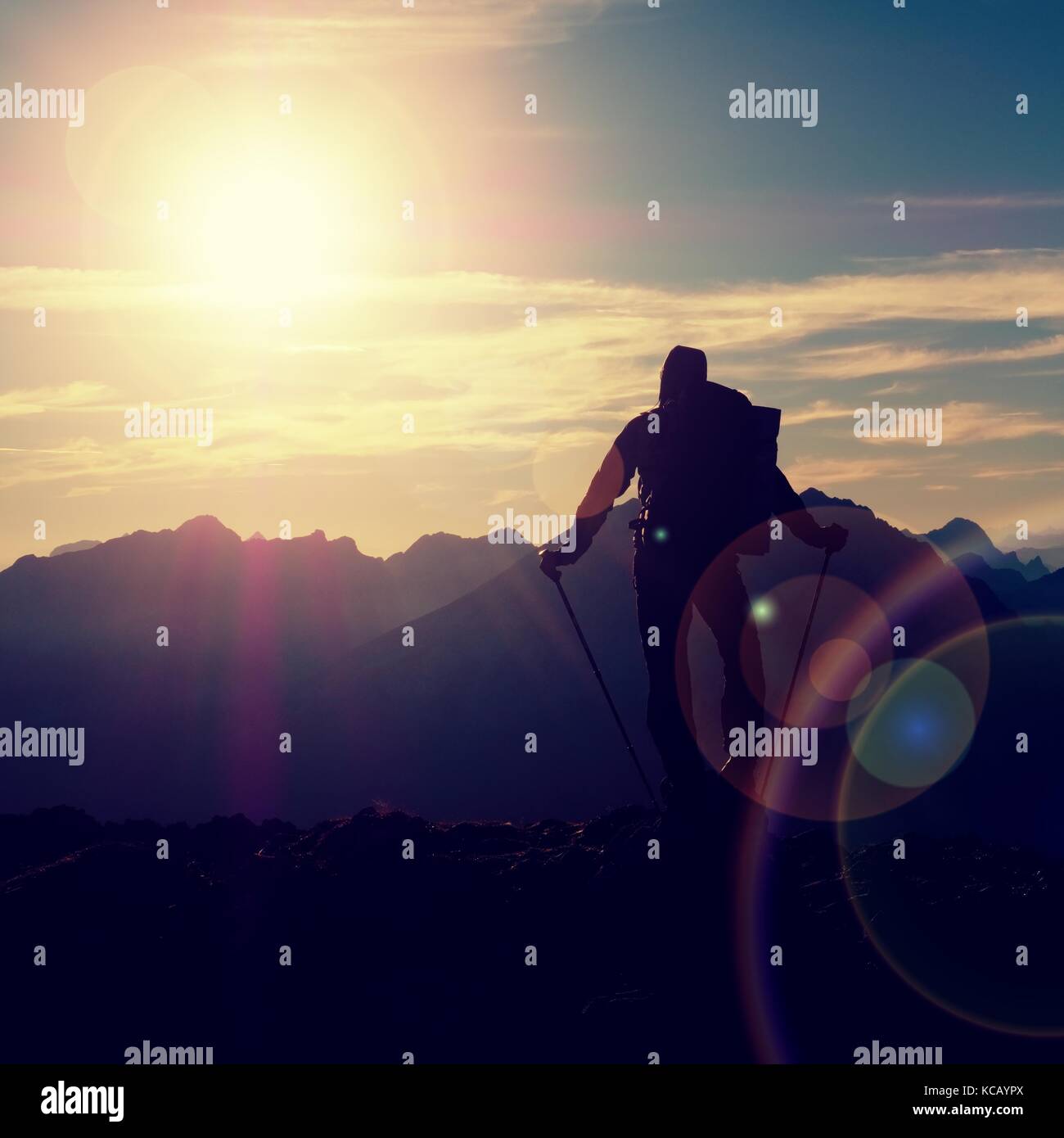 Lens flare light, strong effect. Bow light circles. Hiker takes selfie ...
