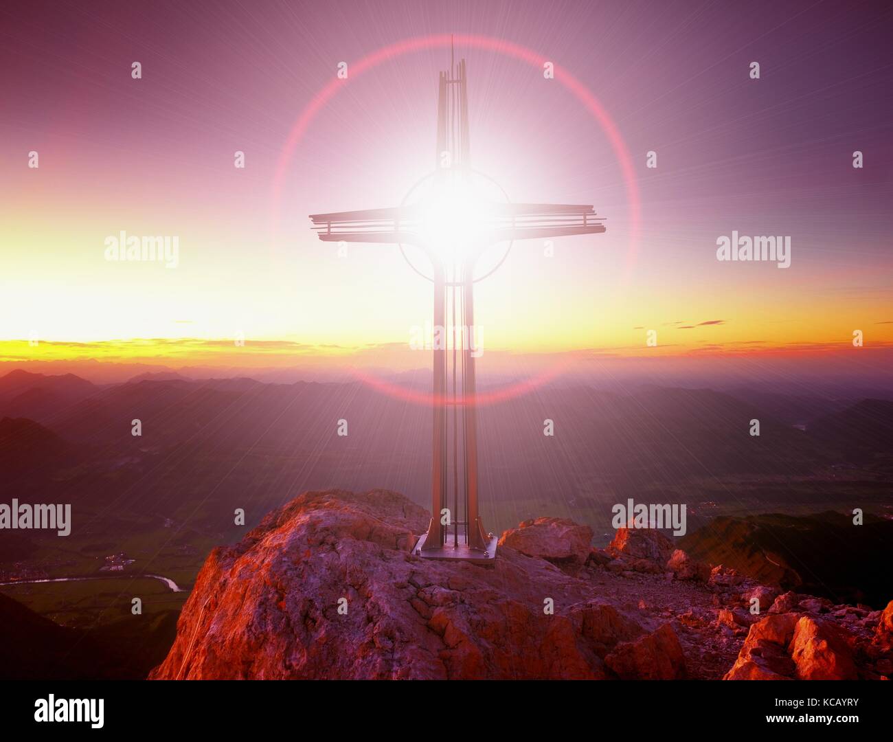 Lens flare light, strong effect. Cross on peak of Hoher Goell. Iron ...