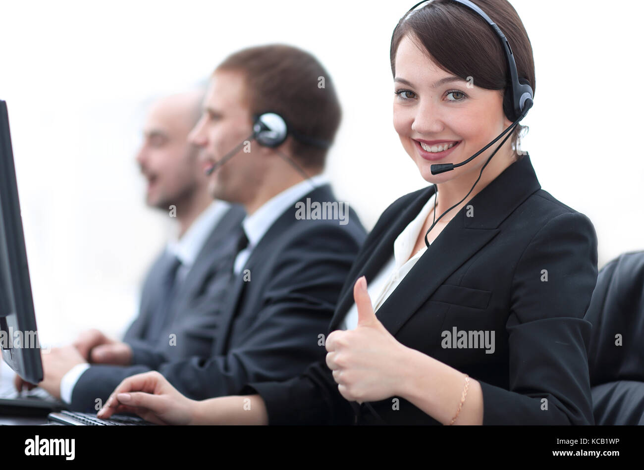 Manager of the call centre shows thumb up sitting at your Desk Stock ...