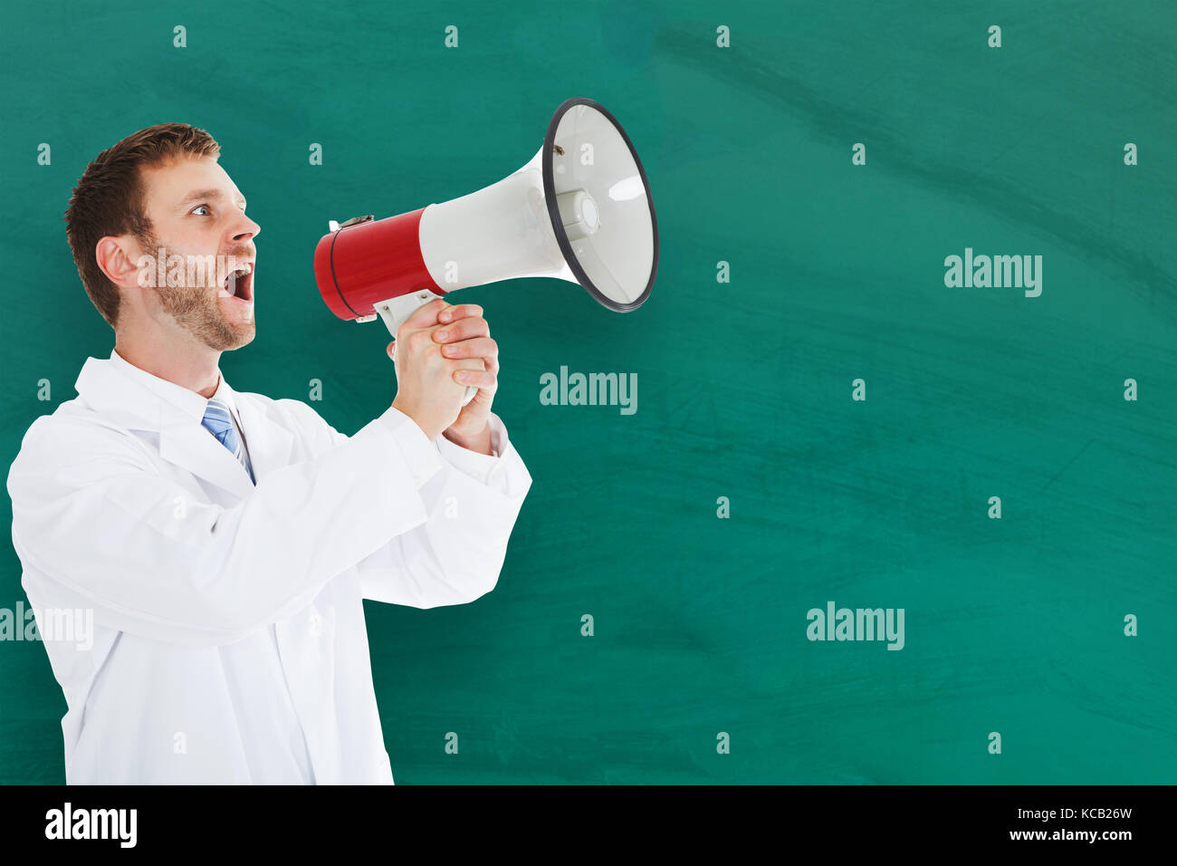 Young Male Doctor Shouting Through Megaphone In Front Of Blackboard ...