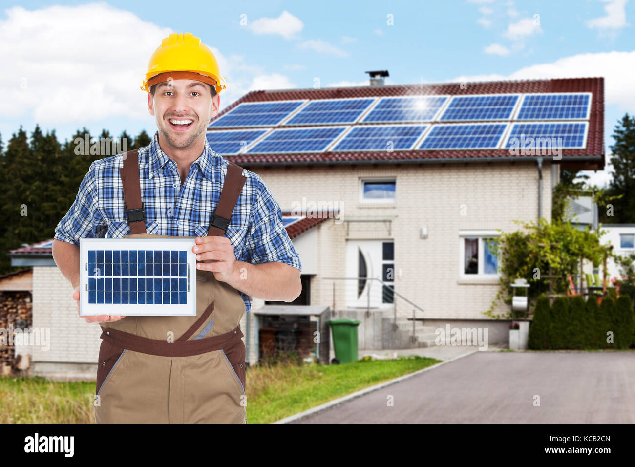 Young man holding solar panel hi-res stock photography and images - Alamy