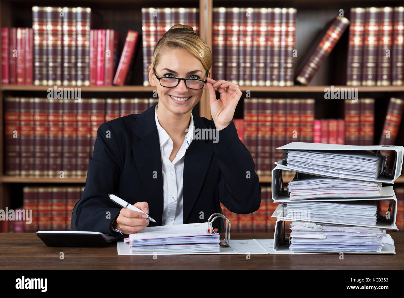 Portrait Of A Successful Female Accountant With Stacked Folders Stock ...