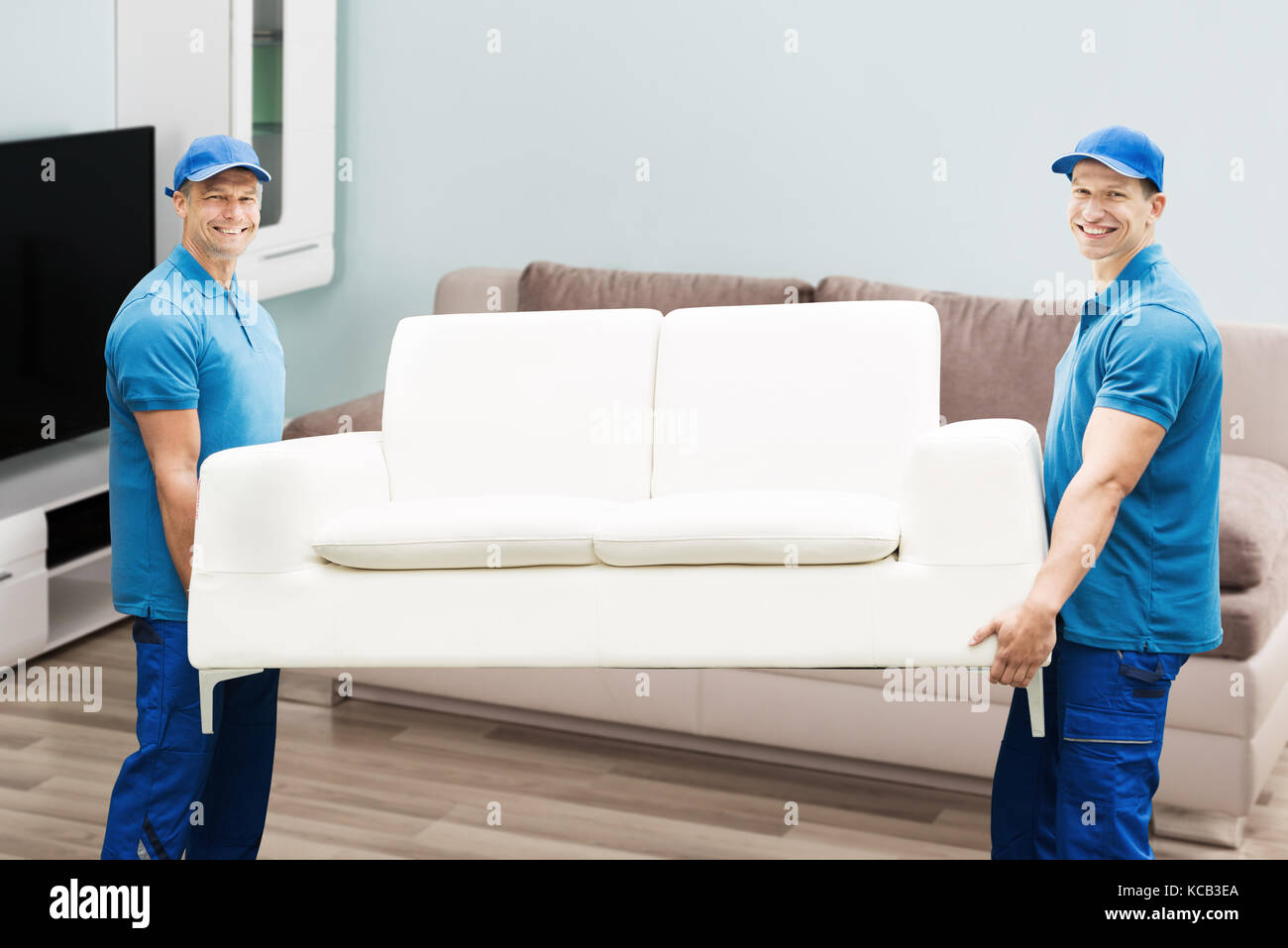 Two men carrying a sofa hi-res stock photography and images - Alamy