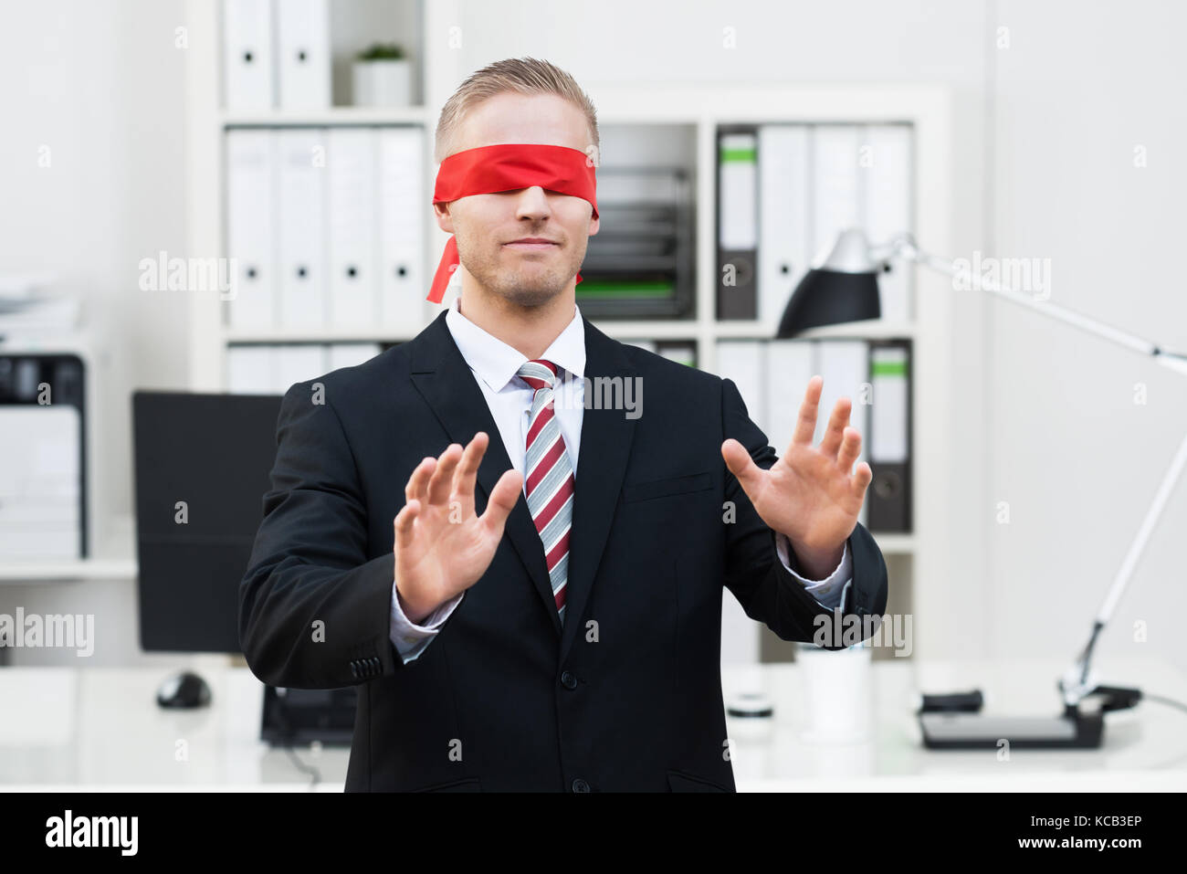 Portrait Of A Blindfolded Young Businessman Gesturing In Office Stock ...