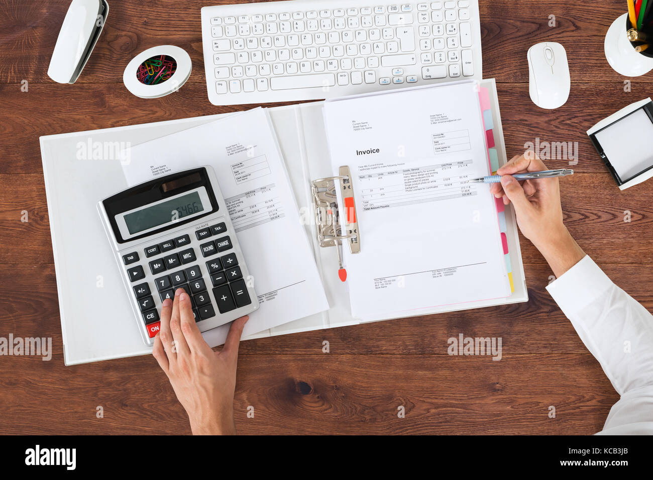 High Angle View Of A Accountant Calculating Invoice Using Calculator At ...