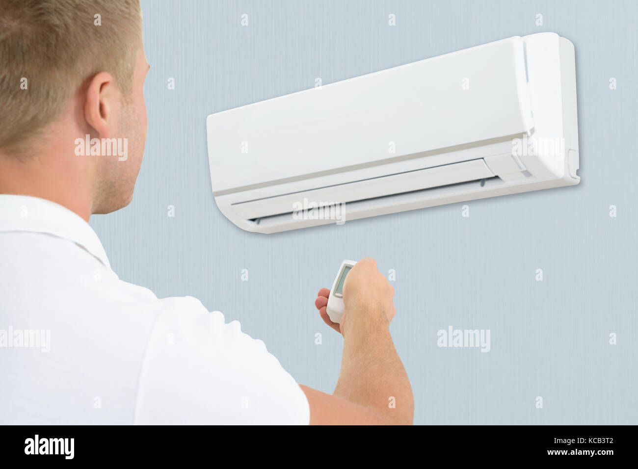 Close-up Of A Man Holding Remote Controller Using Air Conditioner At ...