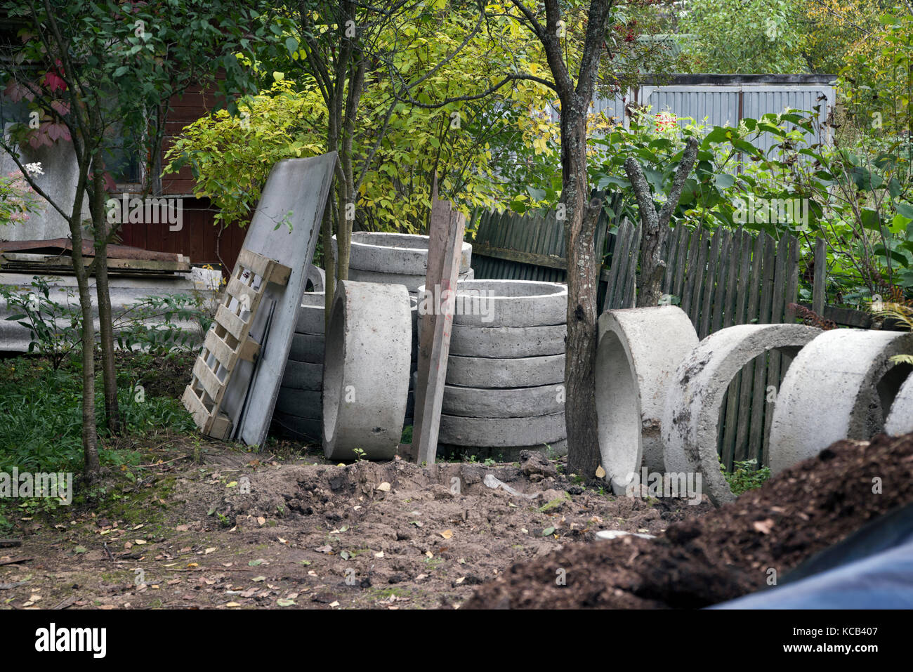 A messy construction area with chamber rings and excavation work ...