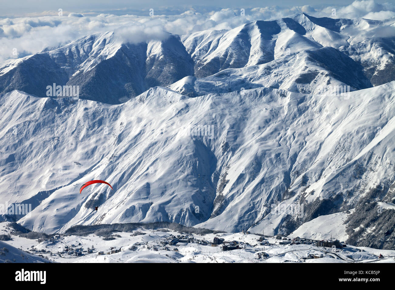 Paragliding at snow mountains over ski resort. Caucasus Mountains in ...