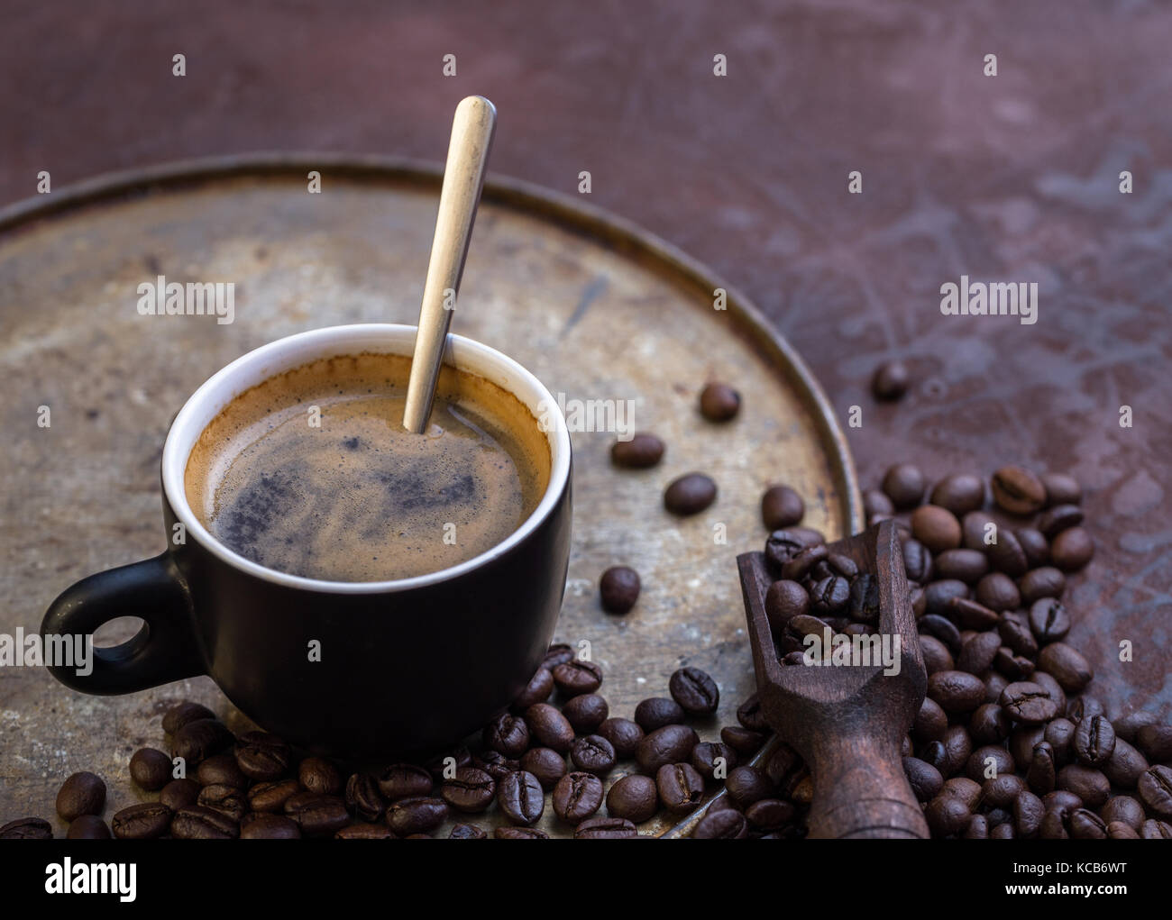 Cup of coffee on rustic background with coffee beans around Stock Photo ...