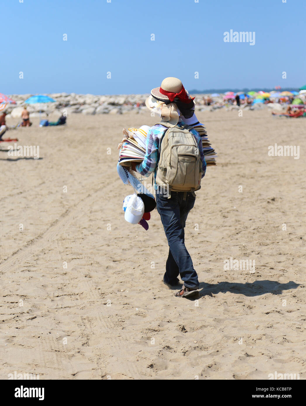 peddler sales clothes and hats on the beach in summer Stock Photo - Alamy