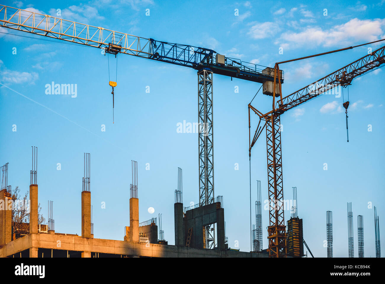 Two tower Cranes on a construction site Stock Photo - Alamy