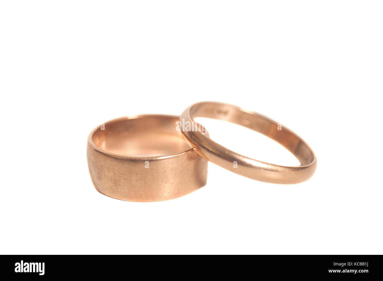Two golden wedding rings isolated on white background Stock Photo - Alamy