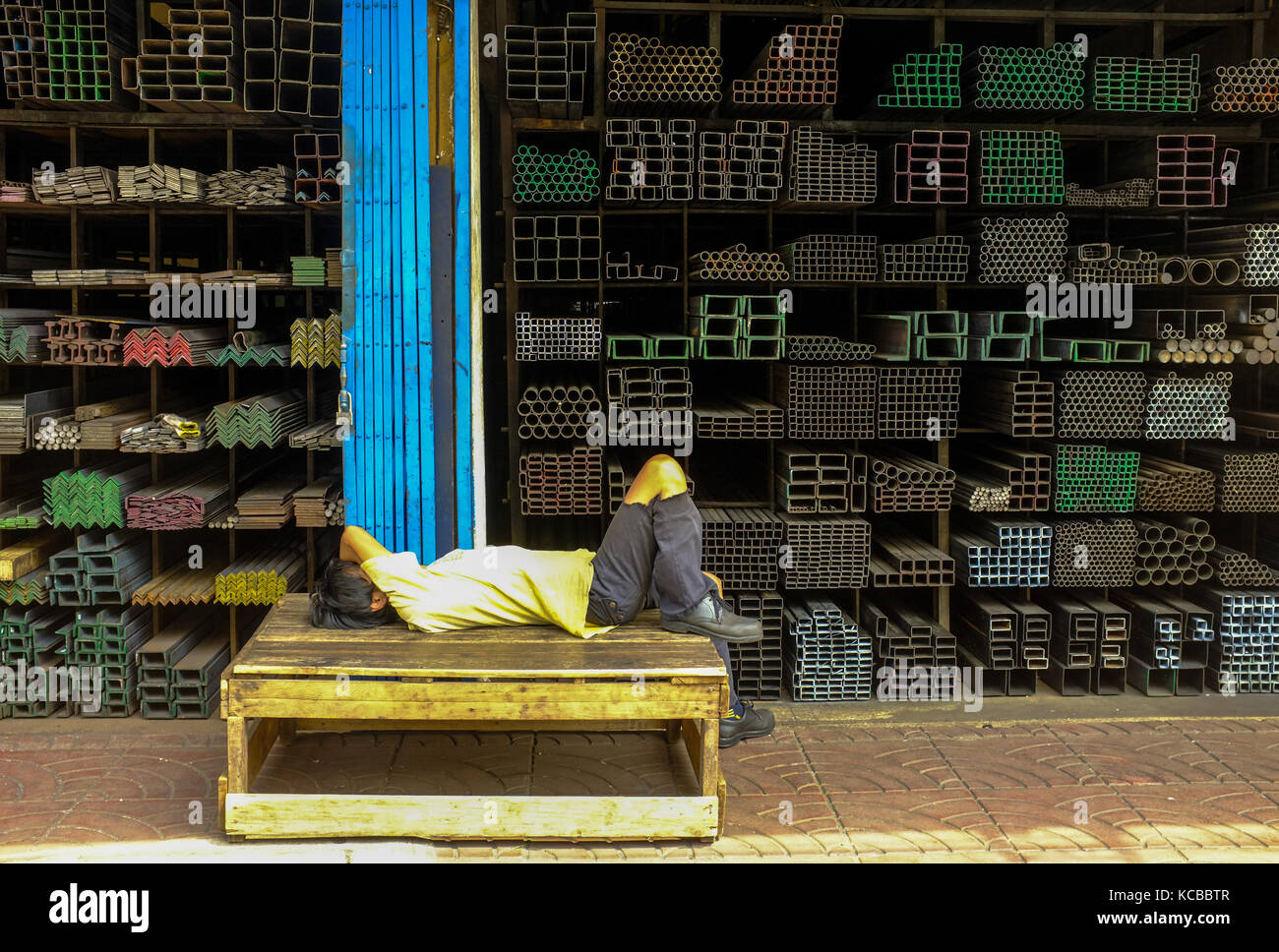Metal workers rest outside their workplace, Chinatown area, Bangkok ...